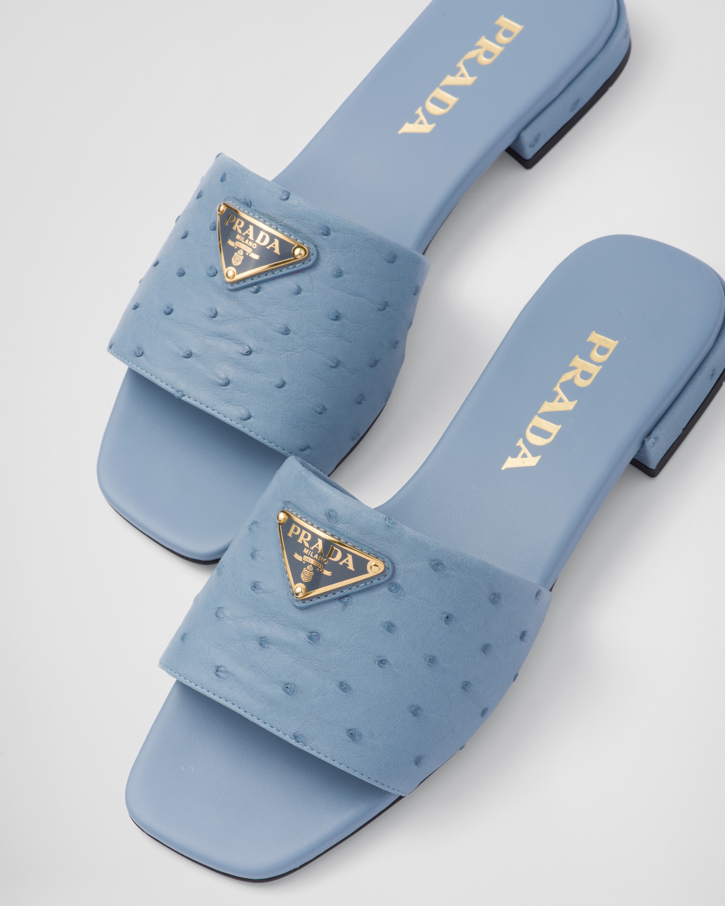 Astral Blue Ostrich leather slides | Prada