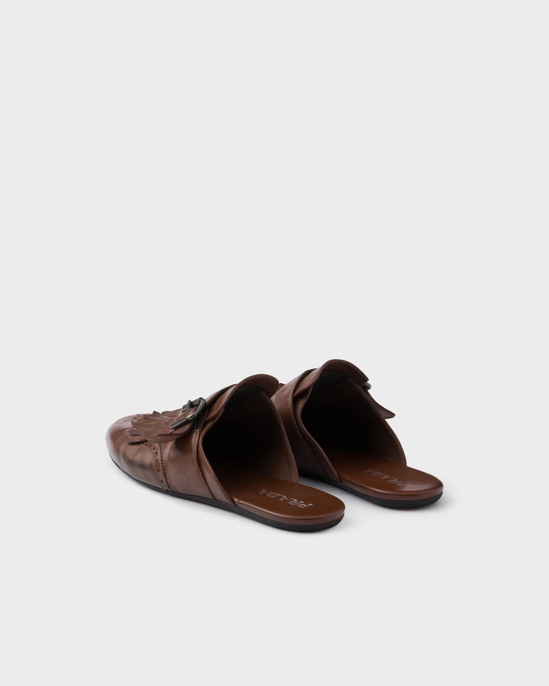 Cognac Shuffle Antiqued Leather Mules With Buckled Strap And Fringe | PRADA